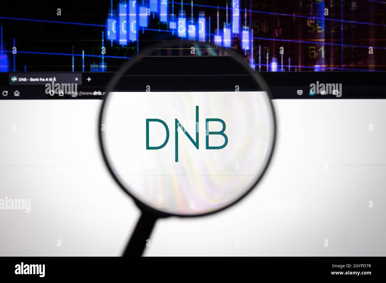 DNB company logo on a website with blurry stock market developments in ...