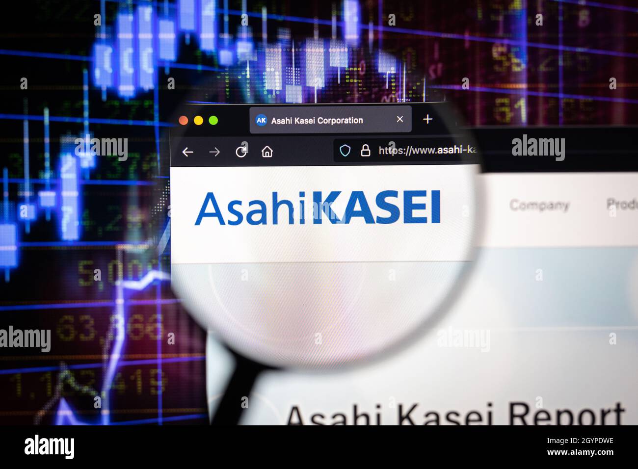 Asahi Kasei company logo on a website with blurry stock market graphs ...