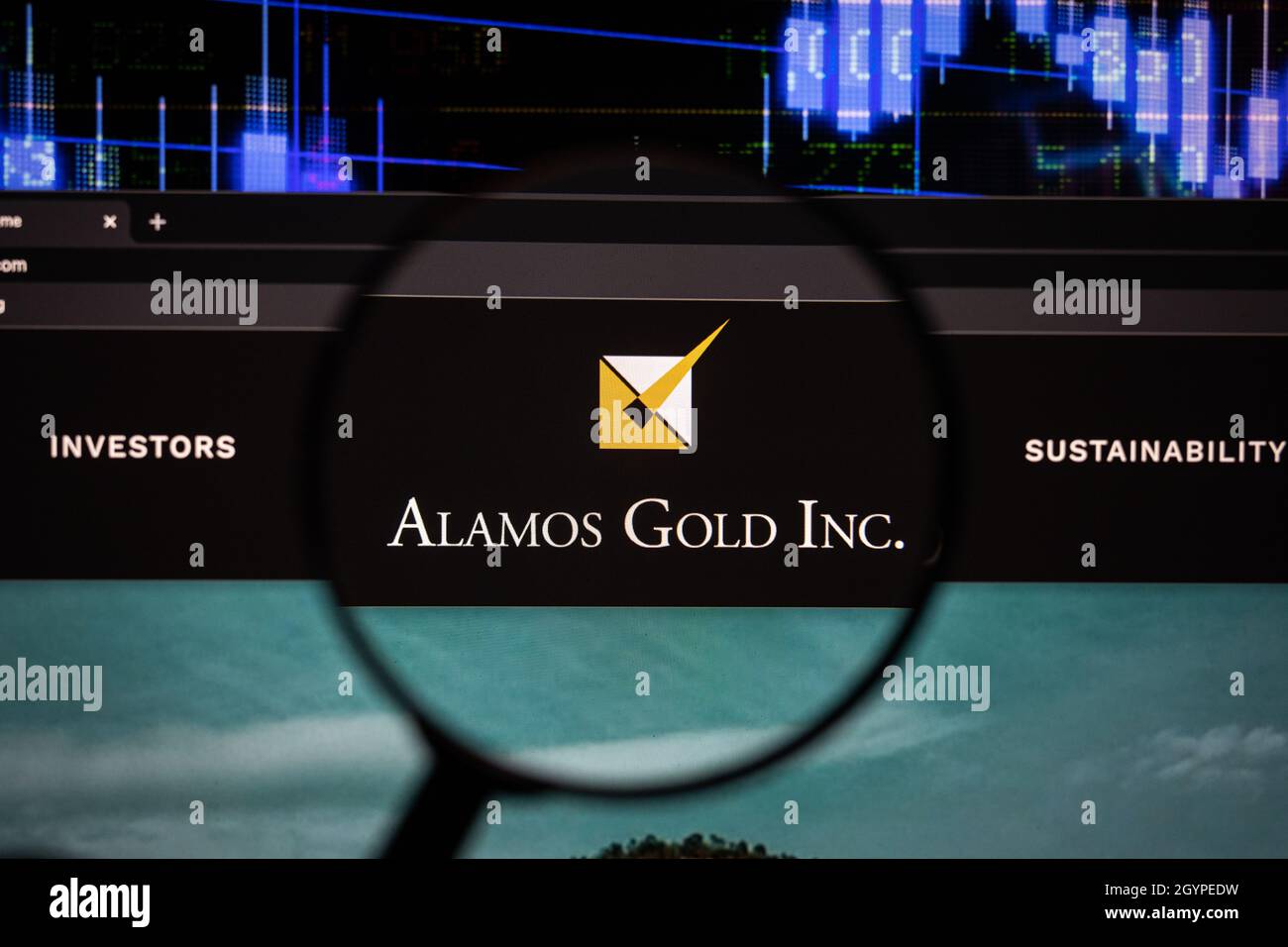 Alamos Gold Inc. company logo on a website with blurry stock market ...