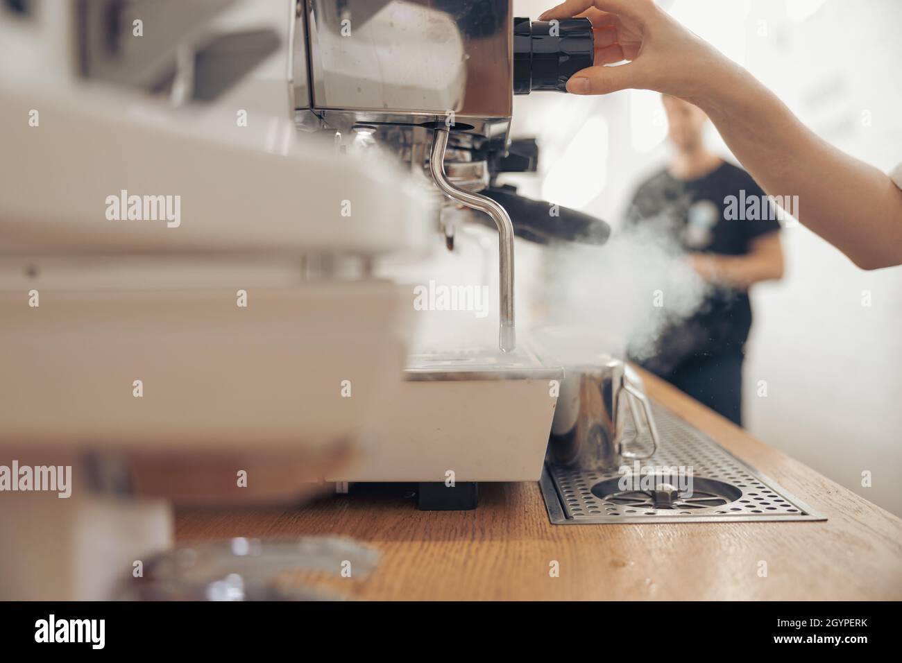 Female barista using coffee machine in cafeteria Stock Photo - Alamy