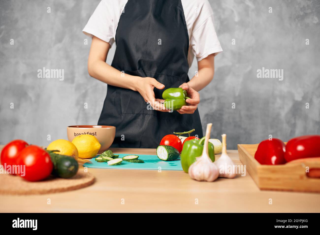 Woman in black apron Cooking healthy eating diet Stock Photo - Alamy