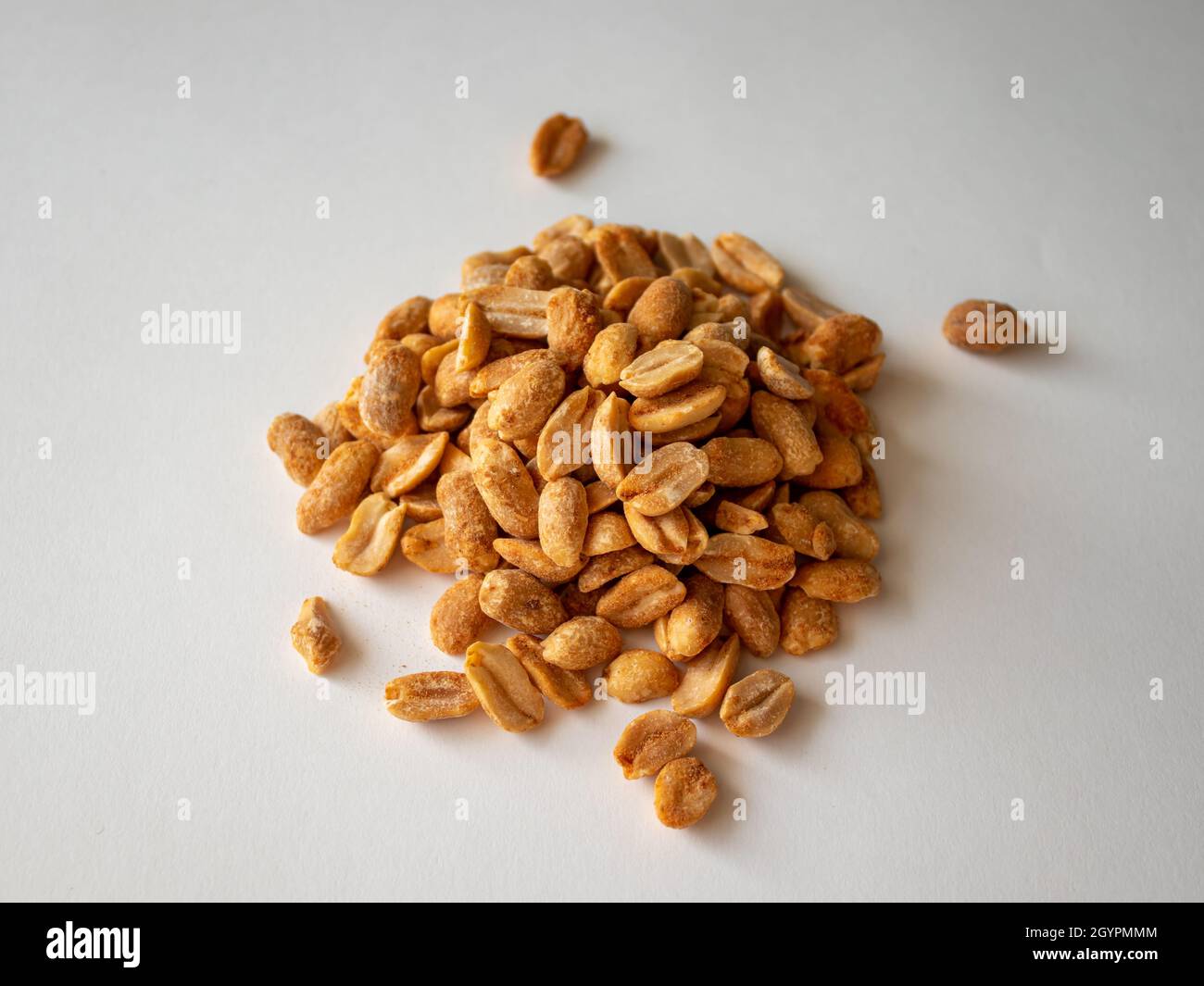 Roasted chili lemon peanuts on white background Stock Photo - Alamy