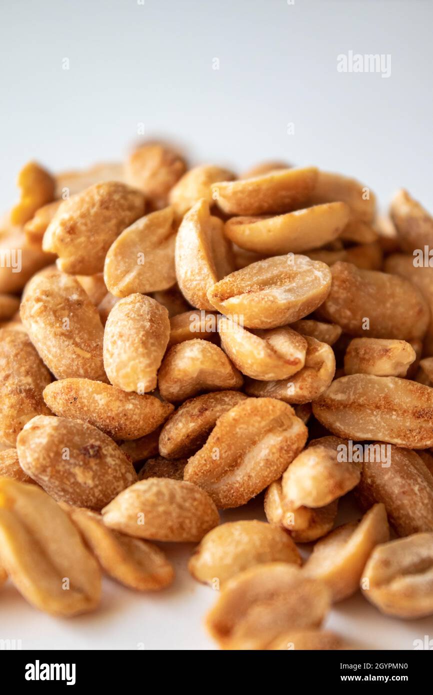 Roasted chili lemon peanuts on white background Stock Photo - Alamy