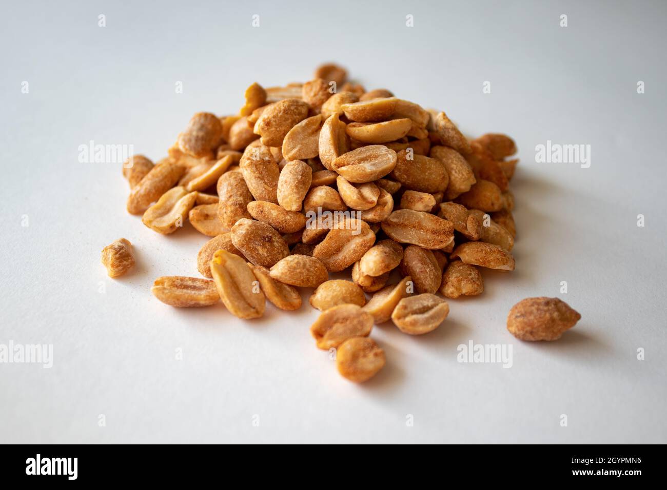Roasted chili lemon peanuts on white background Stock Photo - Alamy