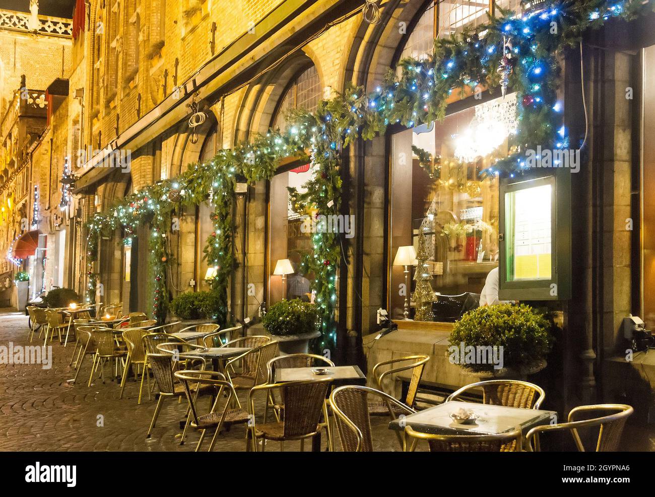 Cafe decorated for Christmas in historic building. Tables and chairs ...