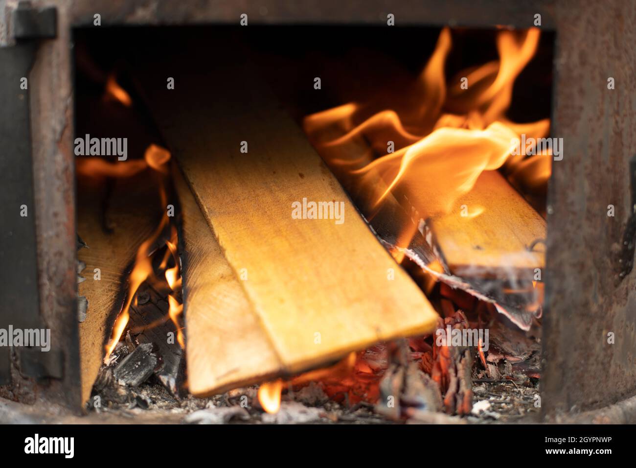 Firewood burns in the stove. Burning wood. Furnace heating. Kindling a ...