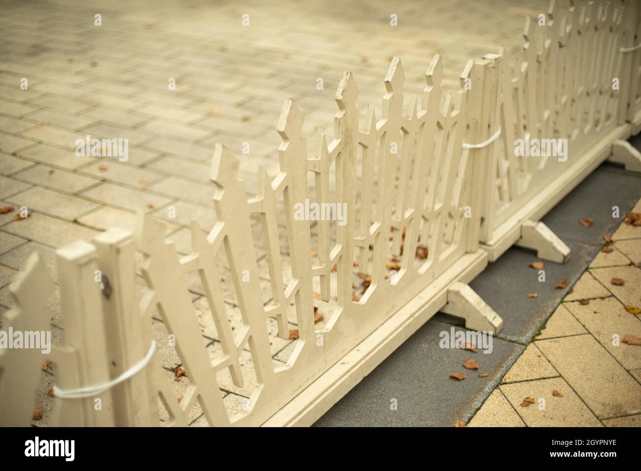 White fence. Small fence. Obstacle for pedestrians in the park Stock ...