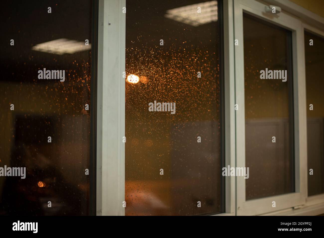 Plastic windows in the evening. Wet glass in the interior. Office ...
