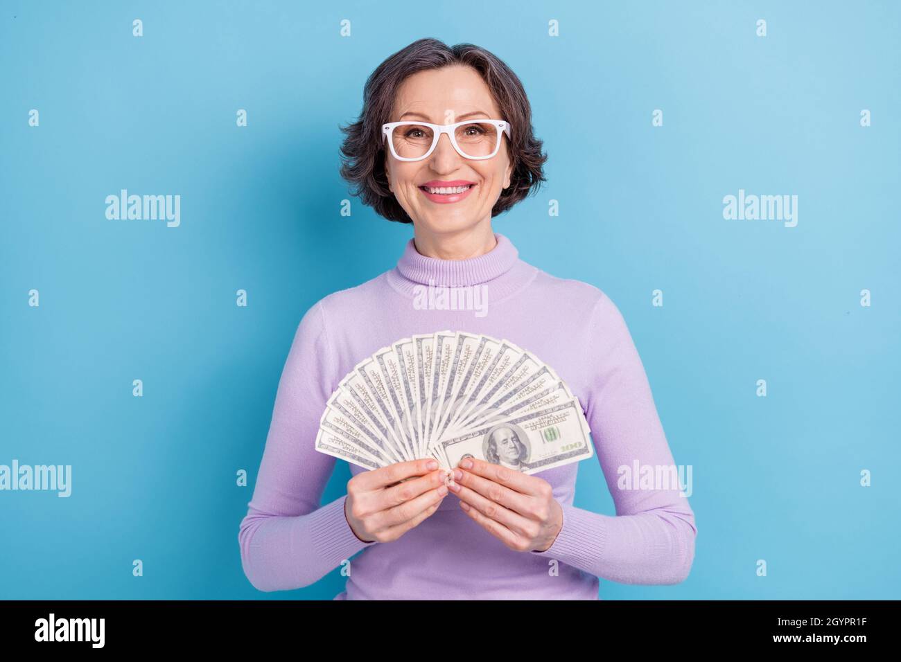 Photo of aged business woman happy positive smile hold cash money ...
