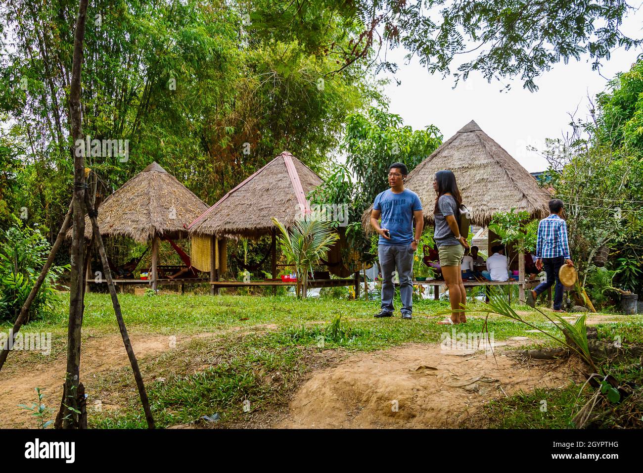 People talking outside of the restaurant hut dining areas Stock Photo ...