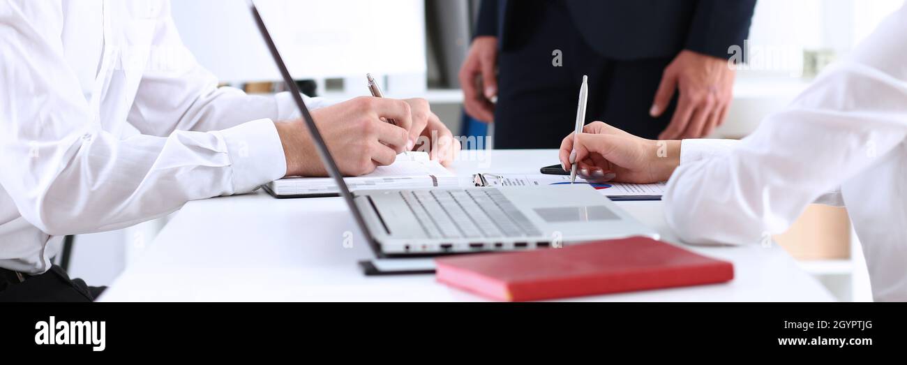 Group of people deliberate on white board problem Stock Photo - Alamy
