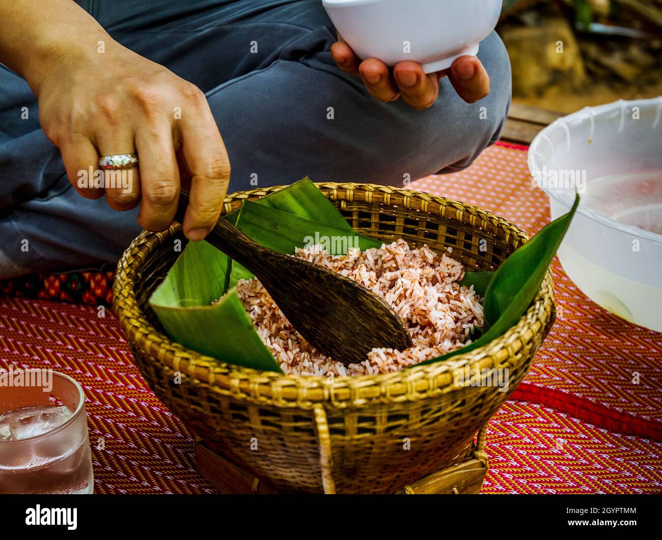 Serving Khmer rice from a basket at a restaurant in Siem Rea as we sit ...