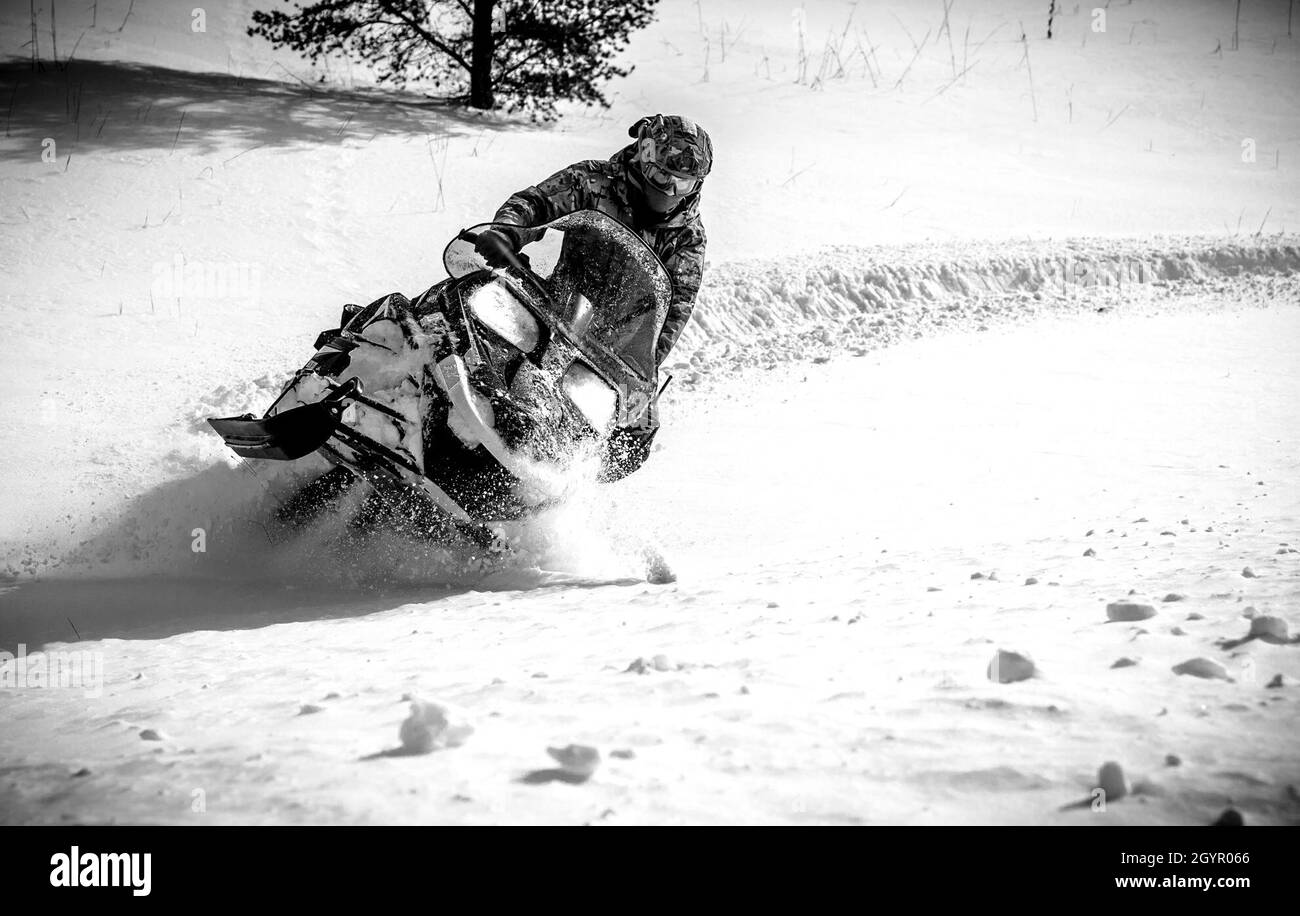 A U.S. Air Force Special Tactics operator rides a snowmobile during ...