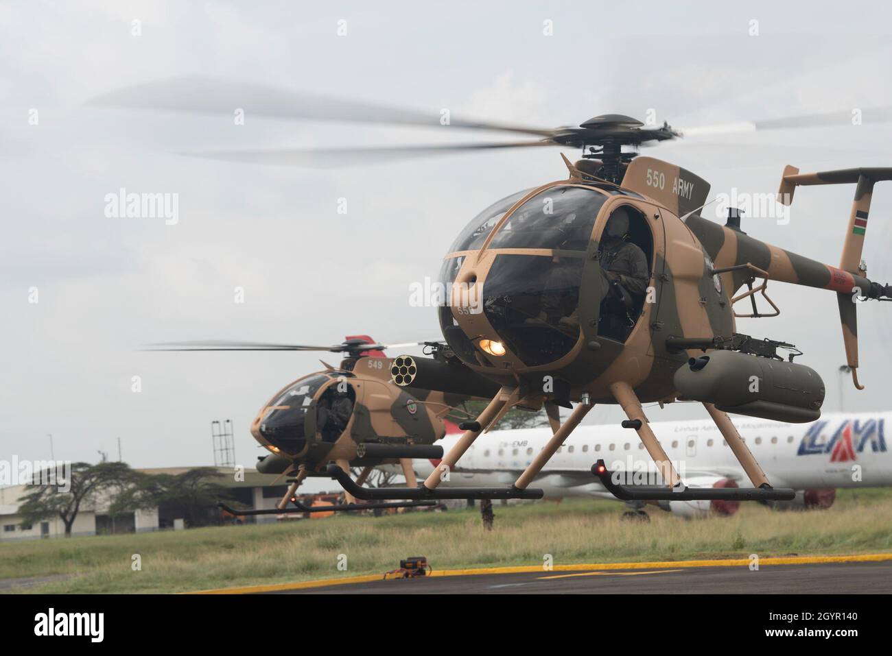 Two MD-530F Cayuse Warrior Helicopters prepare to takeoff during a ...