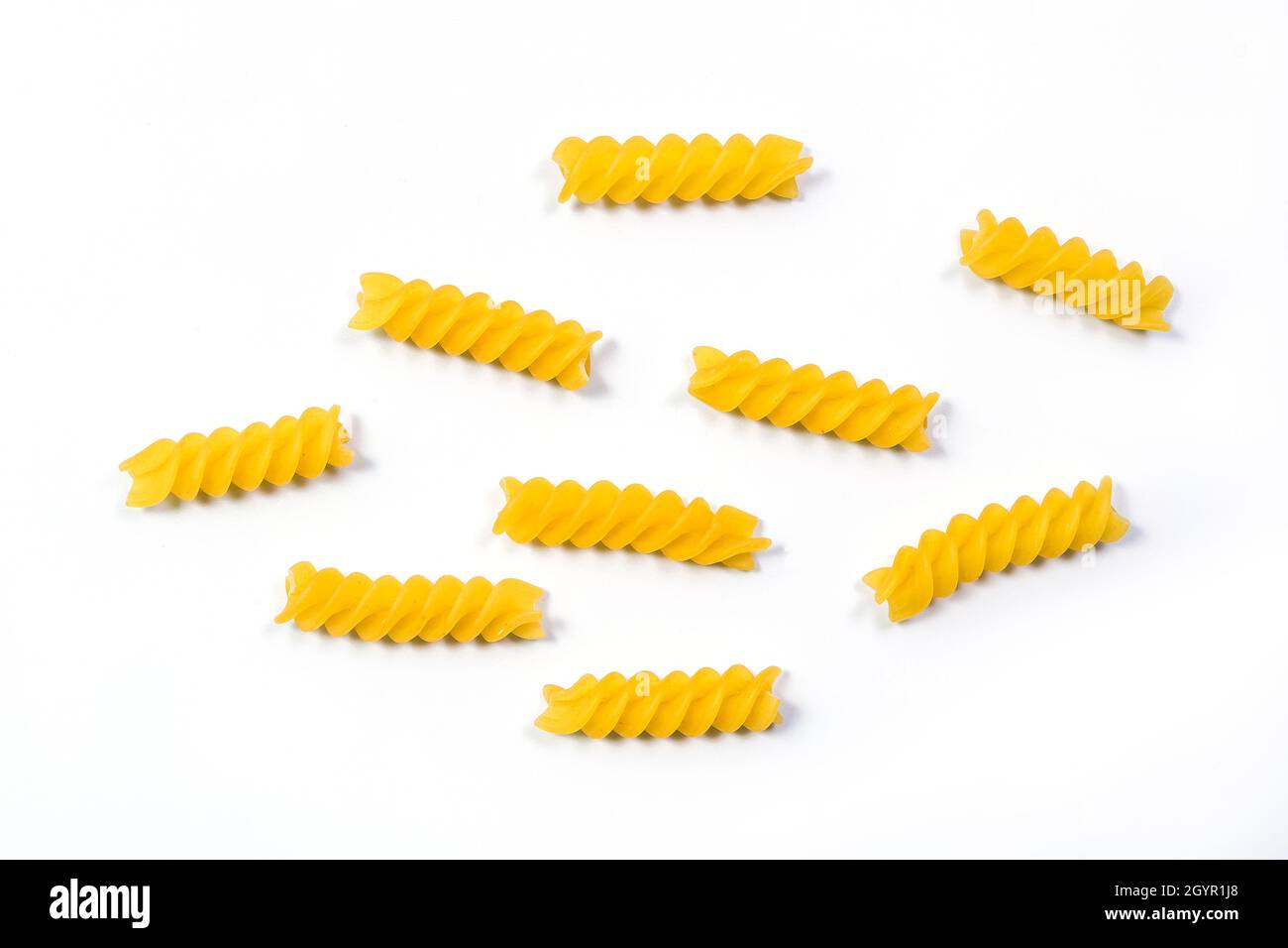 Raw Fusilli pasta, isolated on white background with full depth of ...