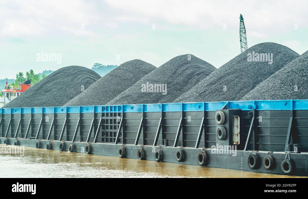 Barge full of black coal cruising on Mahakam River, Borneo, Indonesia ...