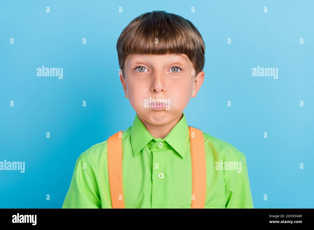 Photo portrait little boy holding air in cheeks wearing shirt isolated ...