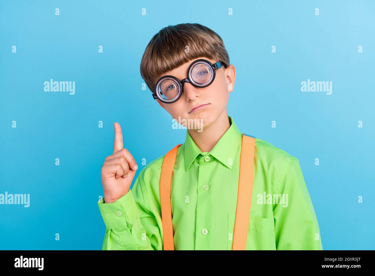 Portrait of attractive brainy schoolboy nerd pointing up solution ...