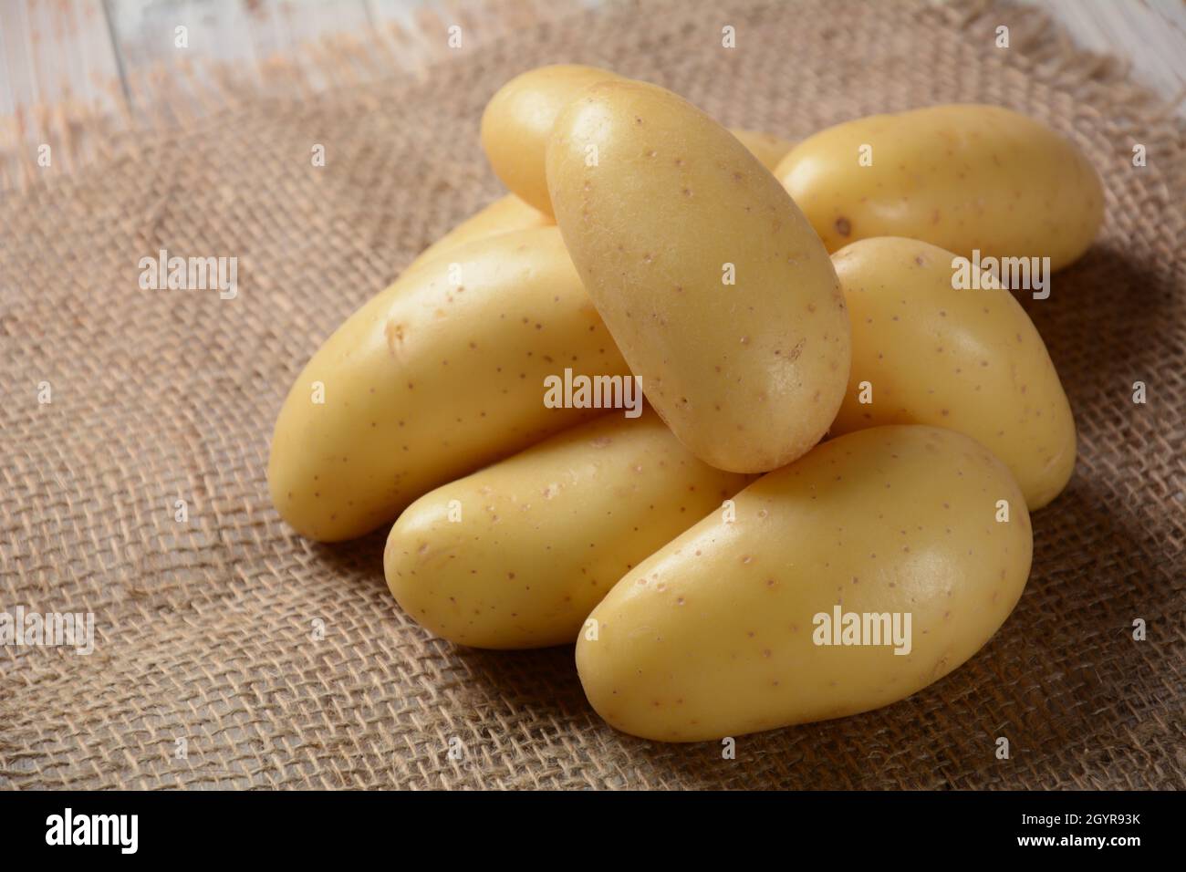 Little yellow potatoes clean ready for cooking on burlap sack as ...