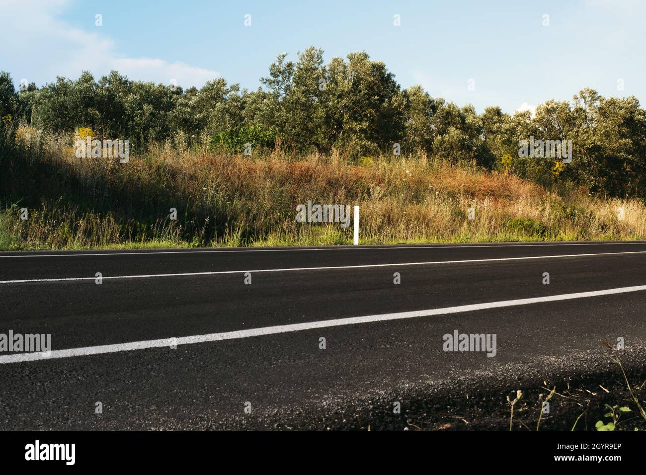 Empty straight country road background in the evening Stock Photo - Alamy