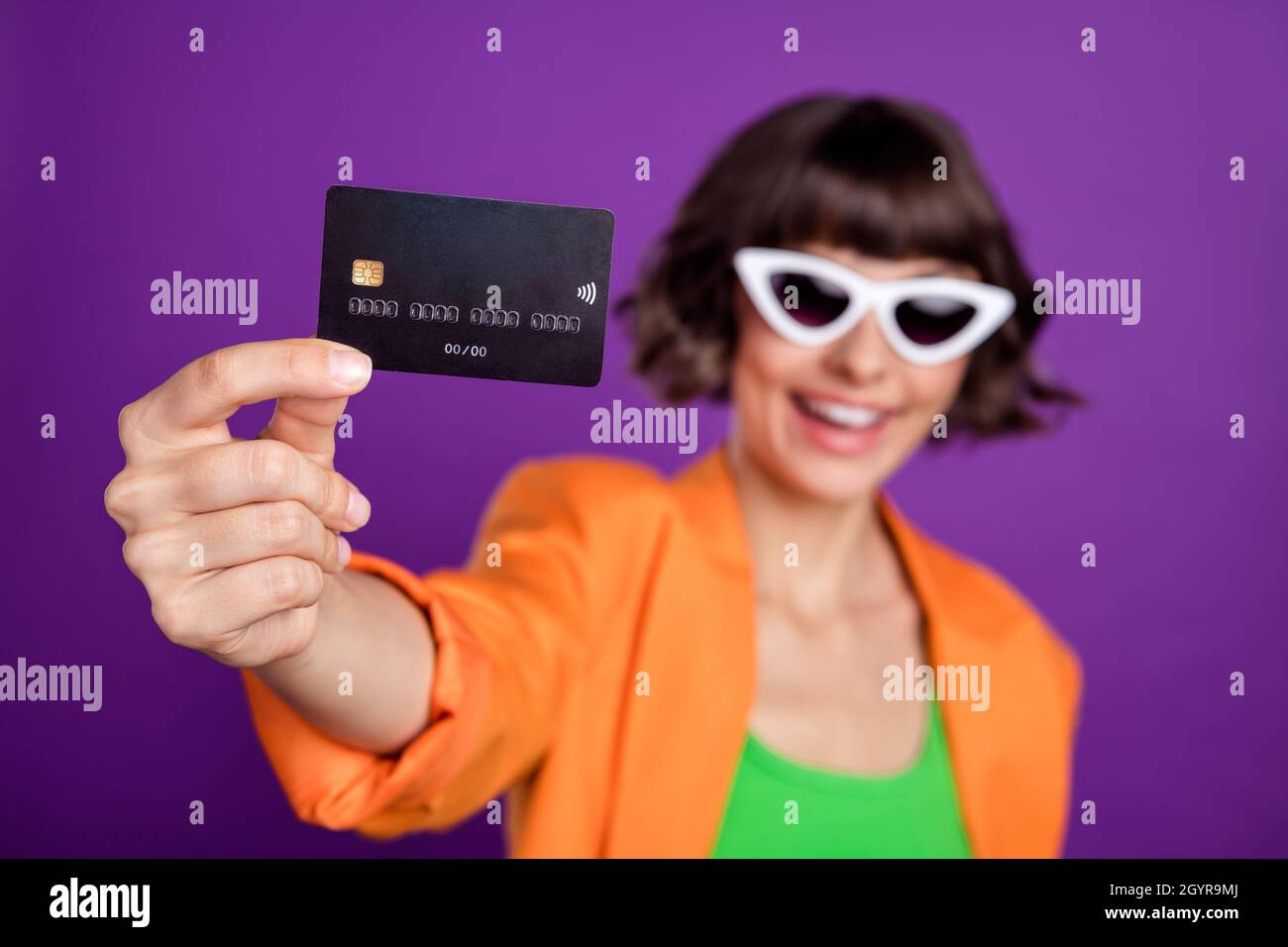 Photo of pretty excited young woman dressed orange blazer dark eyewear ...