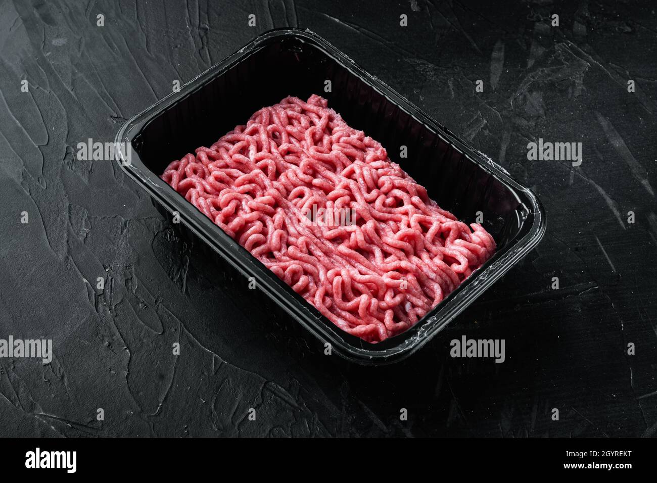 Minced meat in packaging set, on black stone background Stock Photo - Alamy