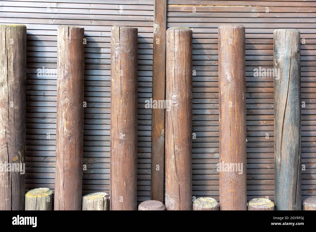 Wood columns near the wall Stock Photo - Alamy