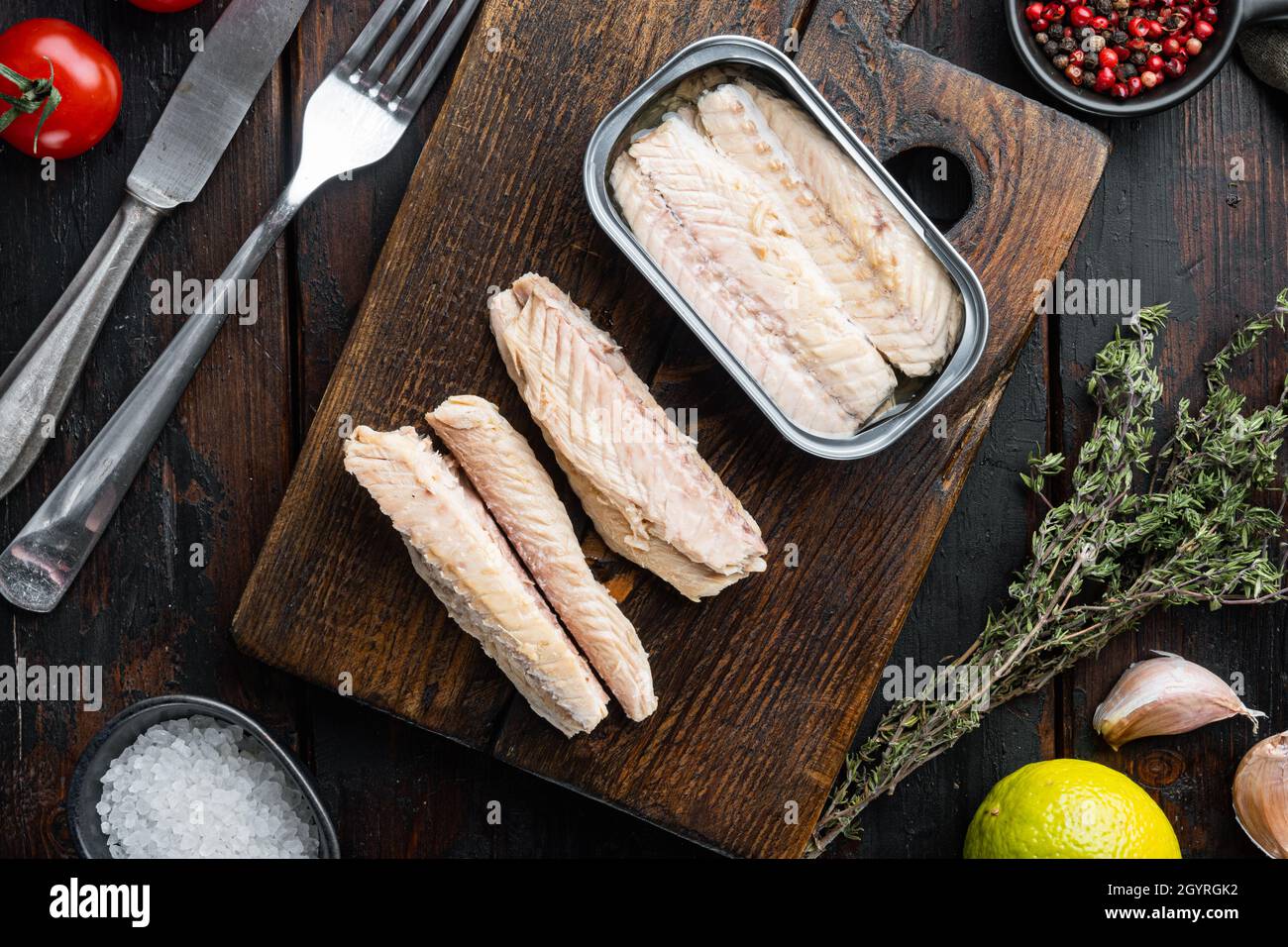 Canned Mackerel Fillets in Tin set, on wooden cutting board, on old ...