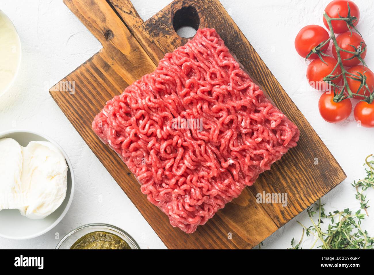 Homemade minced meat in a black bowl with ingredients. Fresh Raw mince ...