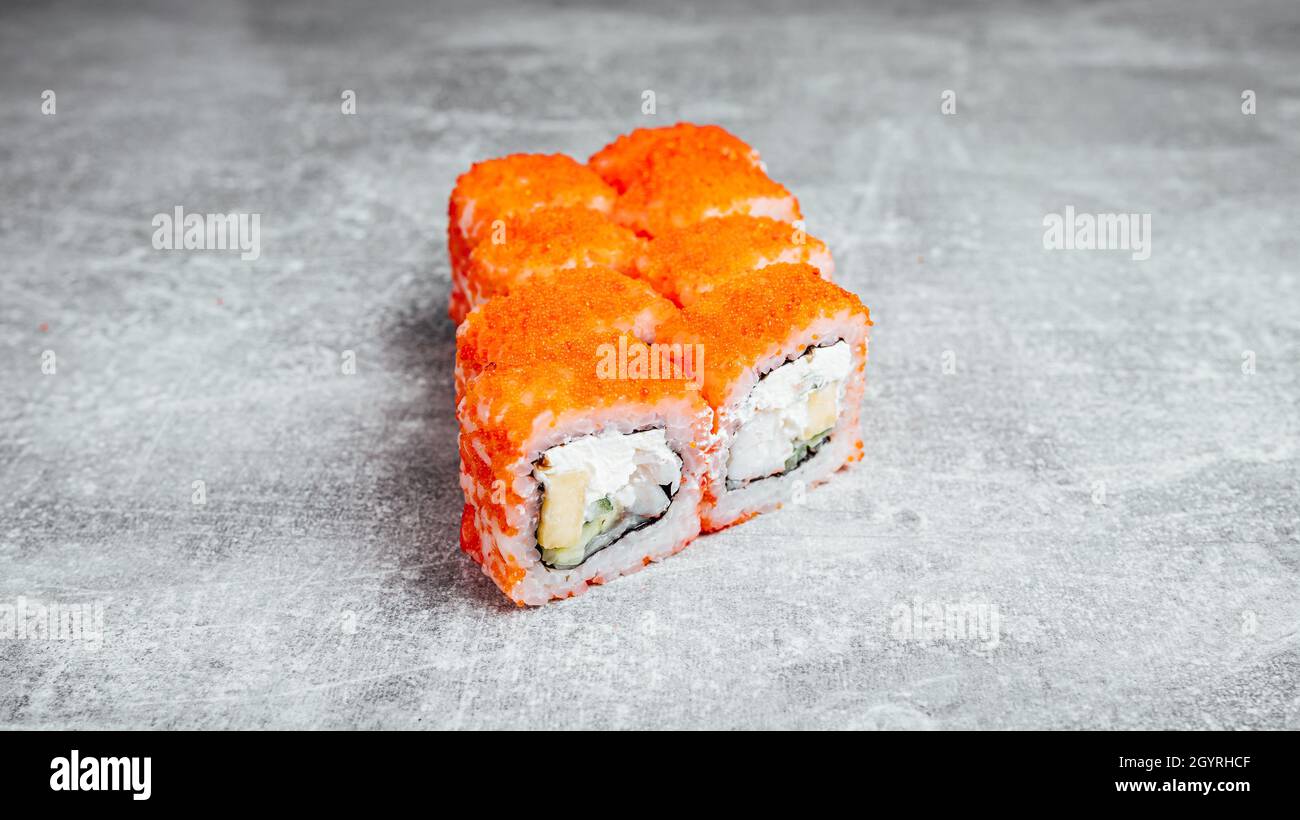 Closeup shot of appetizing "California" sushi rolls on a gray surface ...