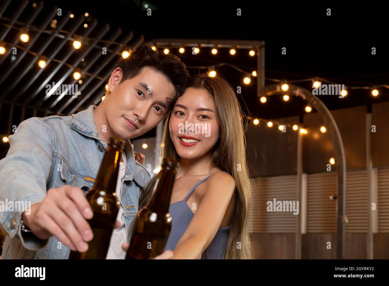 happy asian teenager couple man and woman in love drinking beer alcohol ...