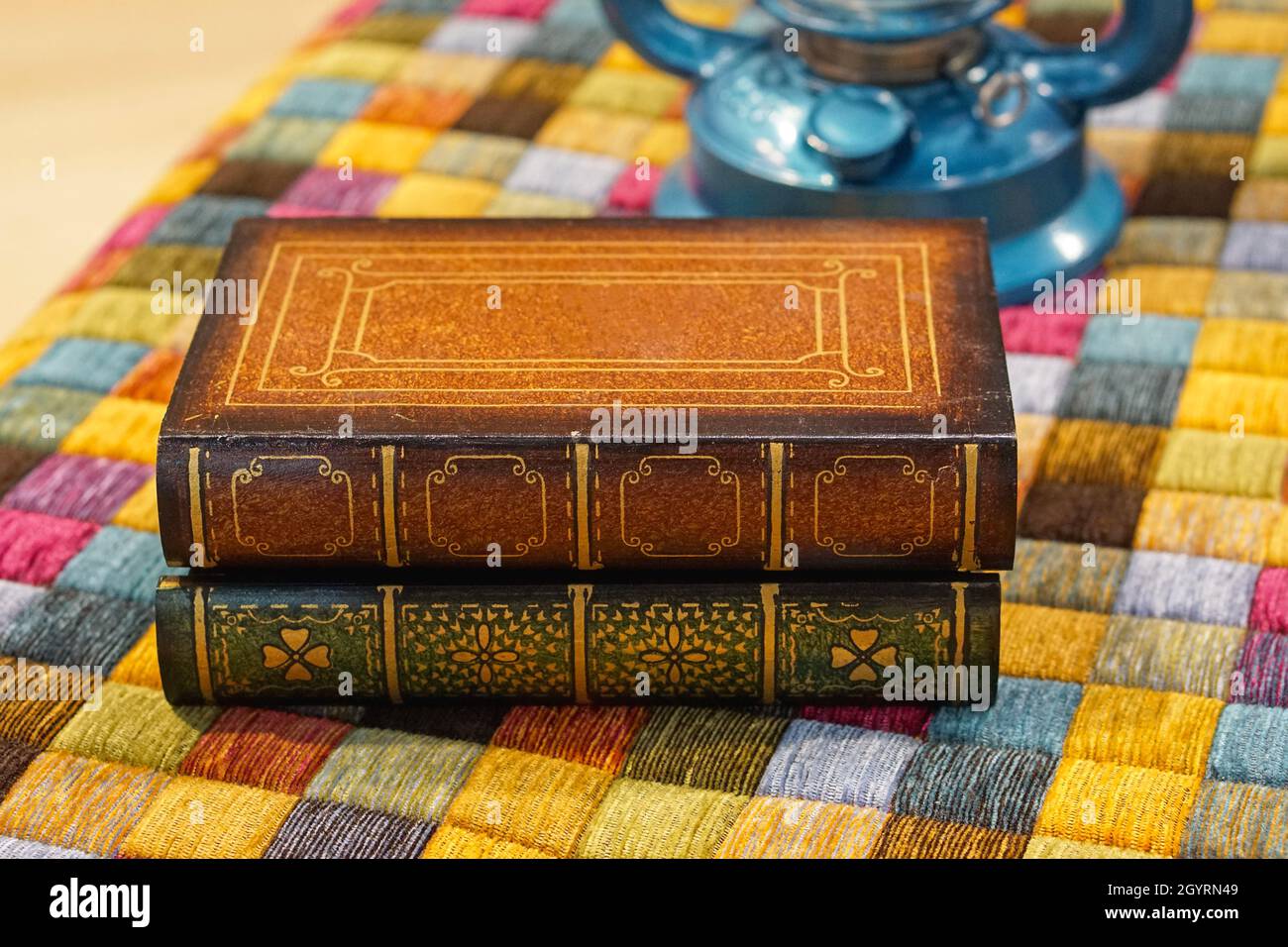 Stacked two old books at colorful sofa Stock Photo - Alamy