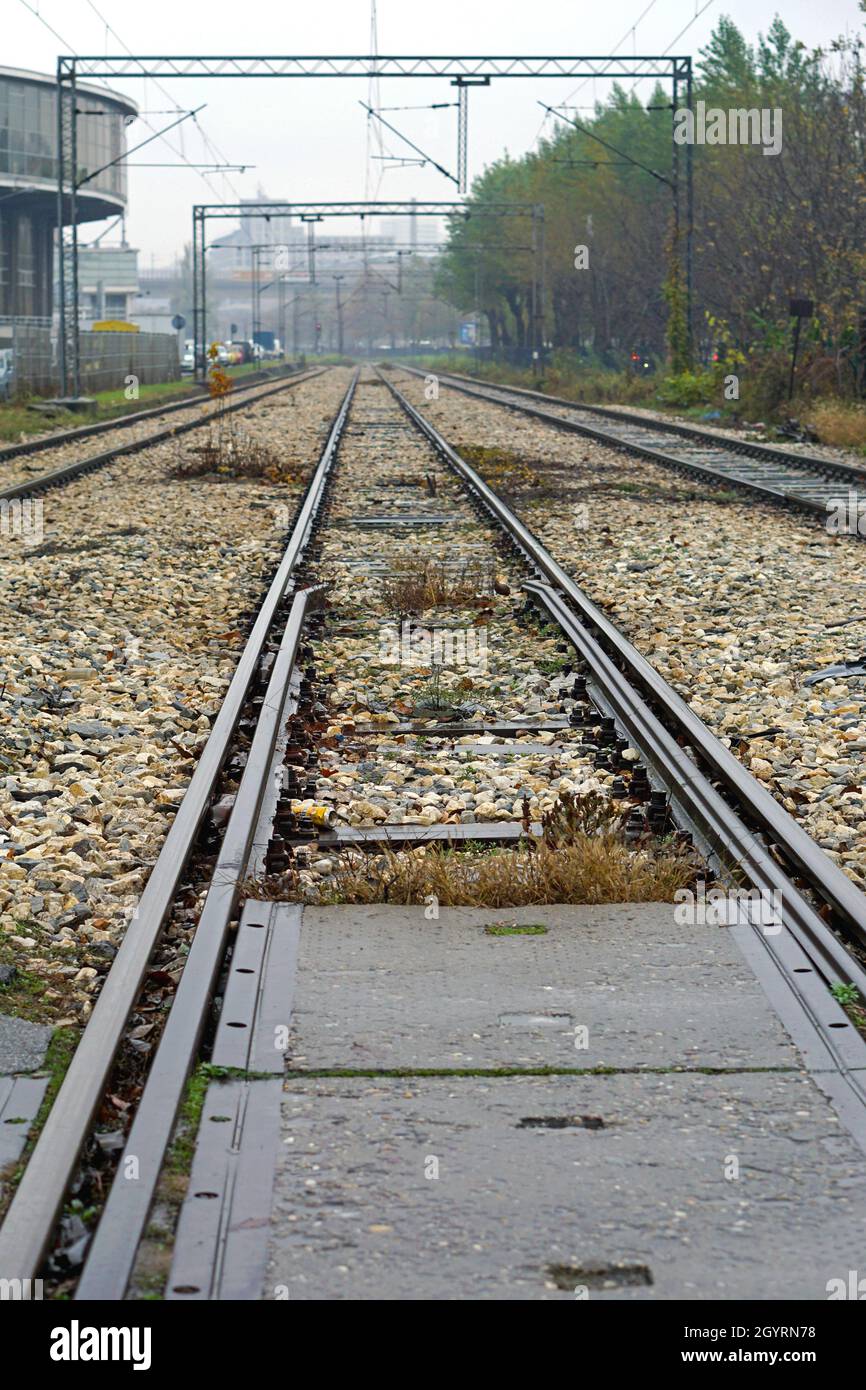 Three tracks railroad with electric lines Stock Photo - Alamy