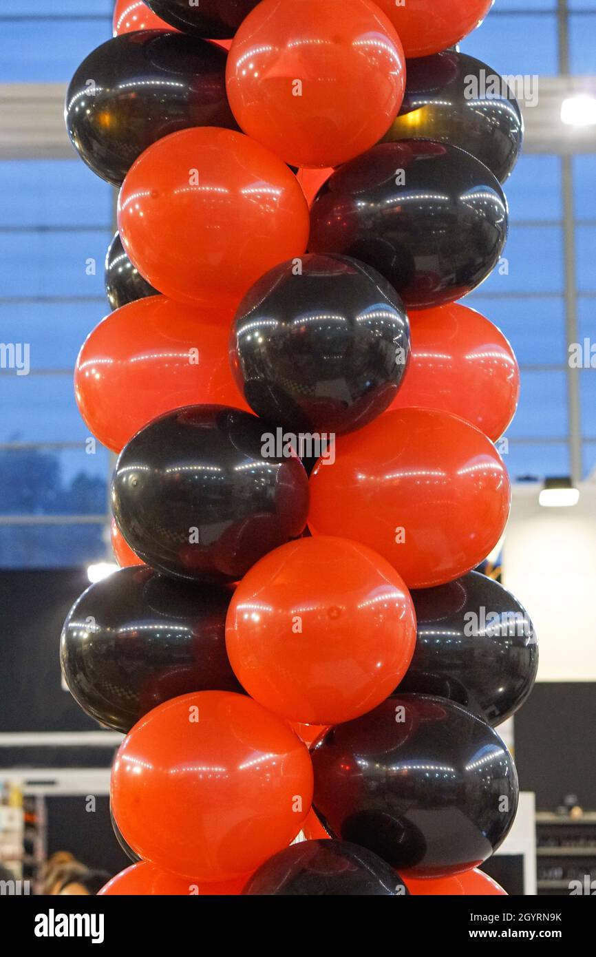 Red and black spiral balloons for party event Stock Photo - Alamy