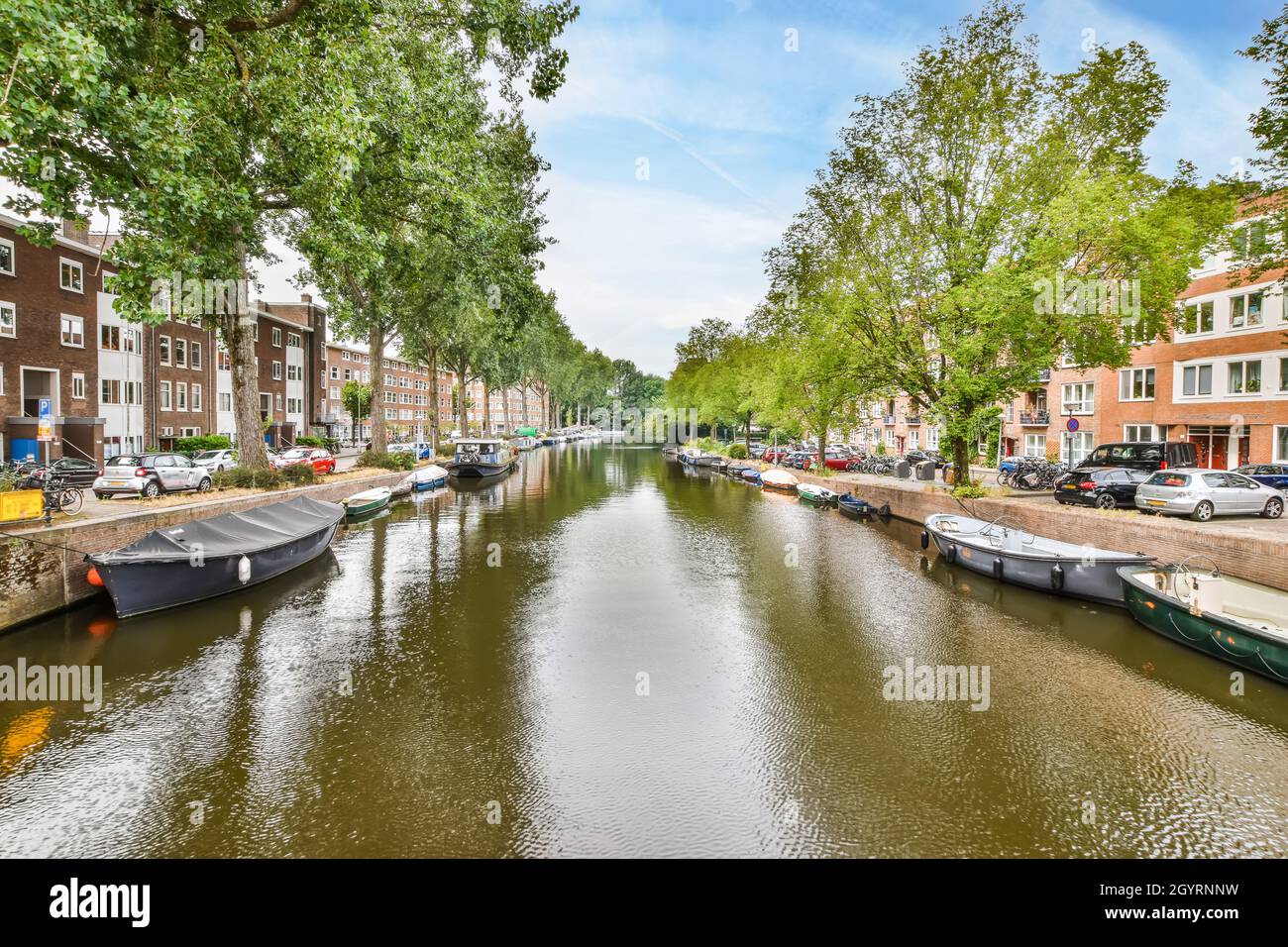 Beautiful buildings by the river full of boats Stock Photo - Alamy