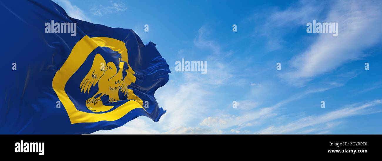 flag of Wing village at cloudy sky background on sunset. panoramic view ...