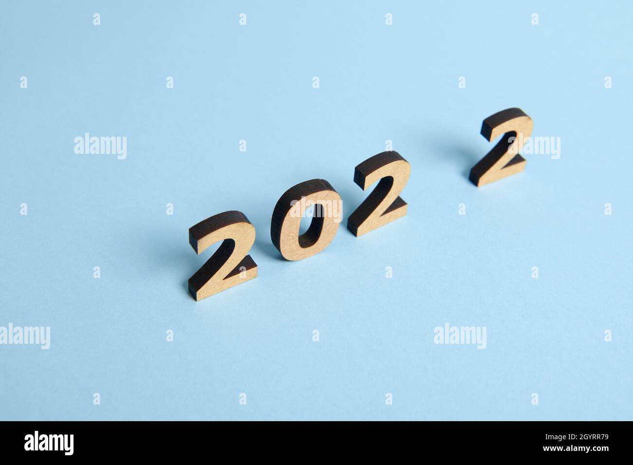 Studio shot with soft shadows falling on a blue surface of wooden ...