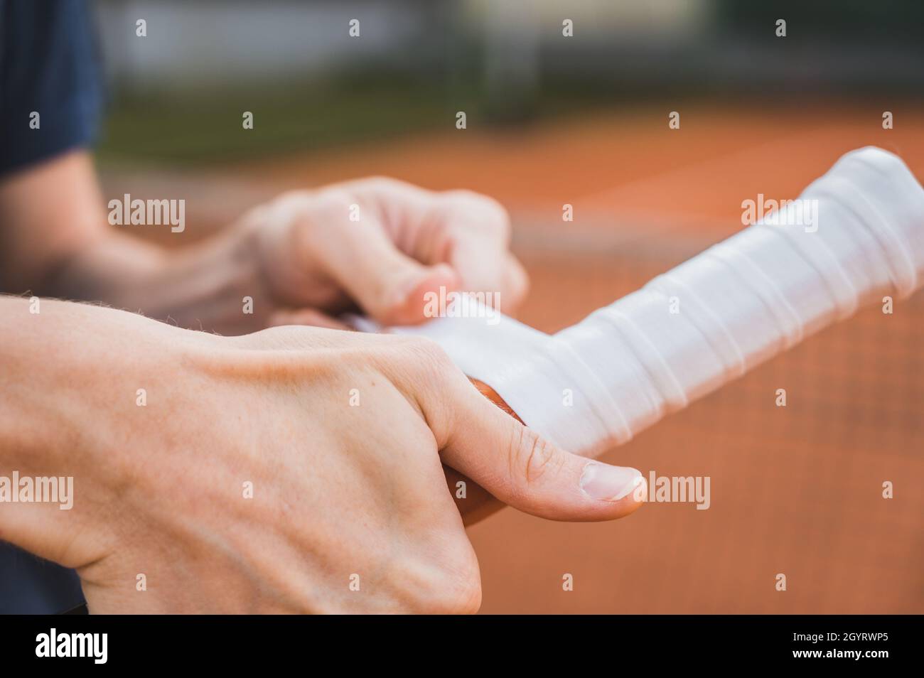 Process of replacement grip on tennis racket. Overgrip. Close-up of ...