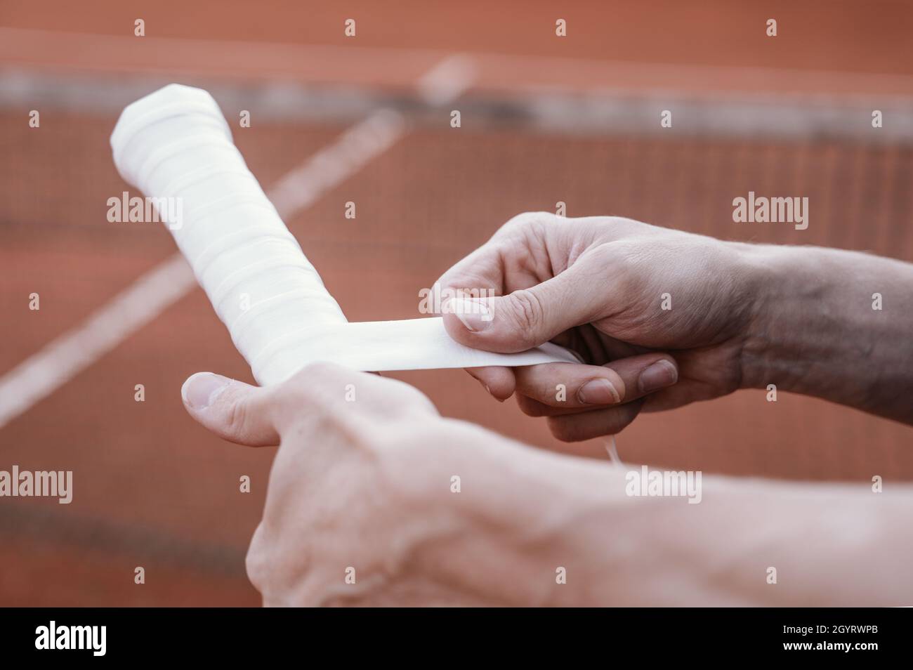 Process of replacement grip on tennis racket. Overgrip. Close-up of ...