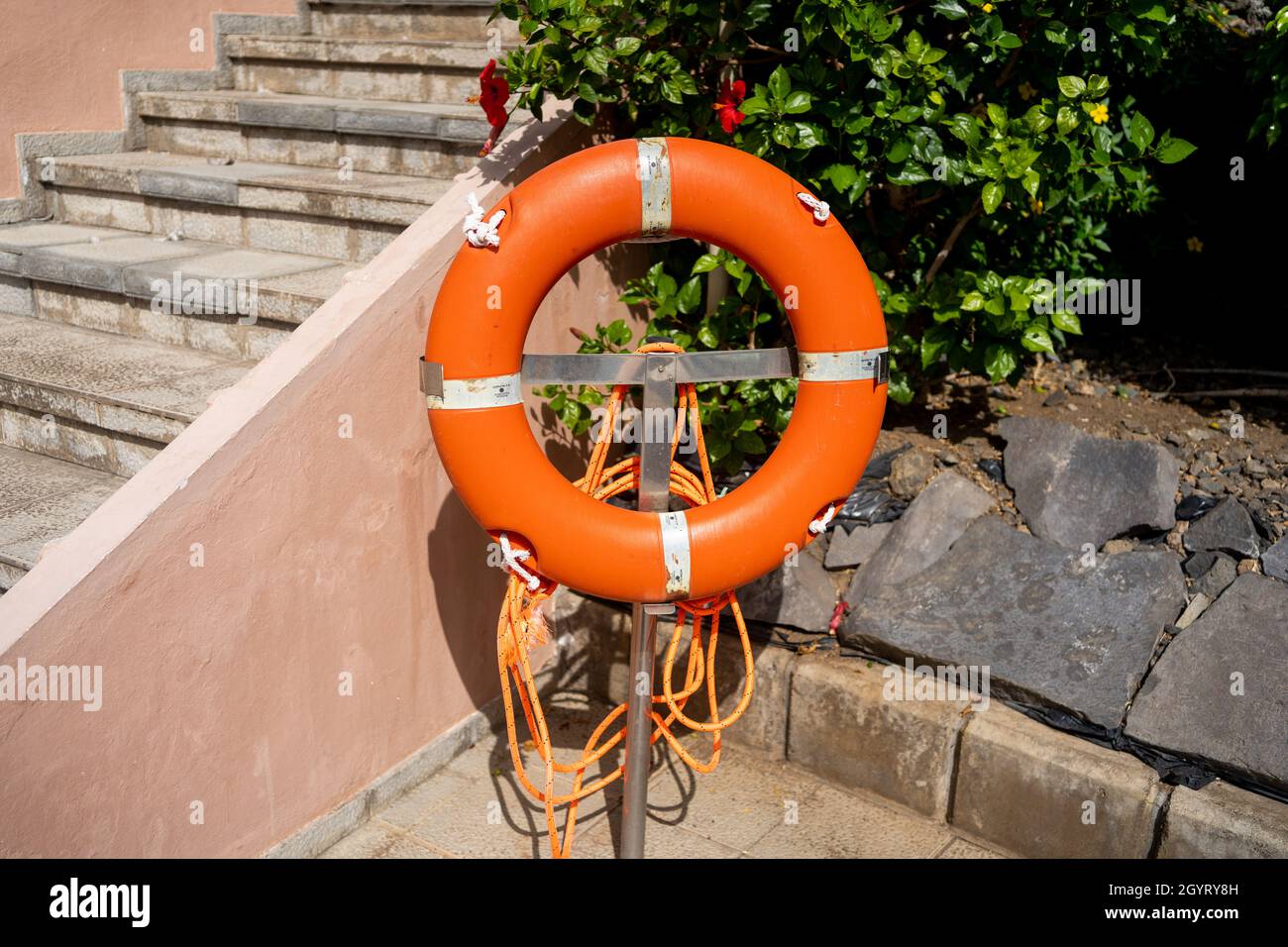 Orange SOS ring hanging in a park Stock Photo - Alamy