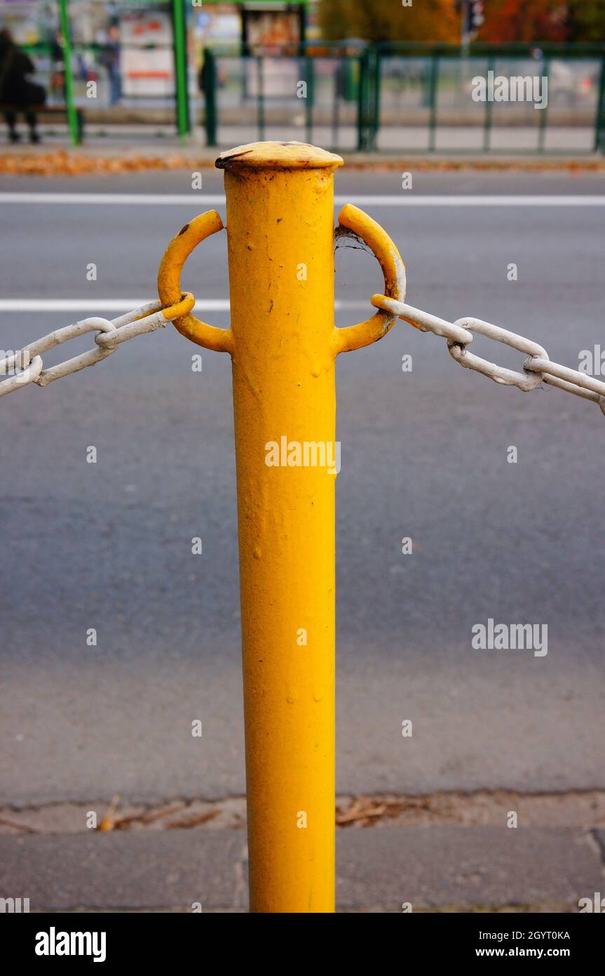 Chain barrier on the yellow pole outdoors Stock Photo - Alamy