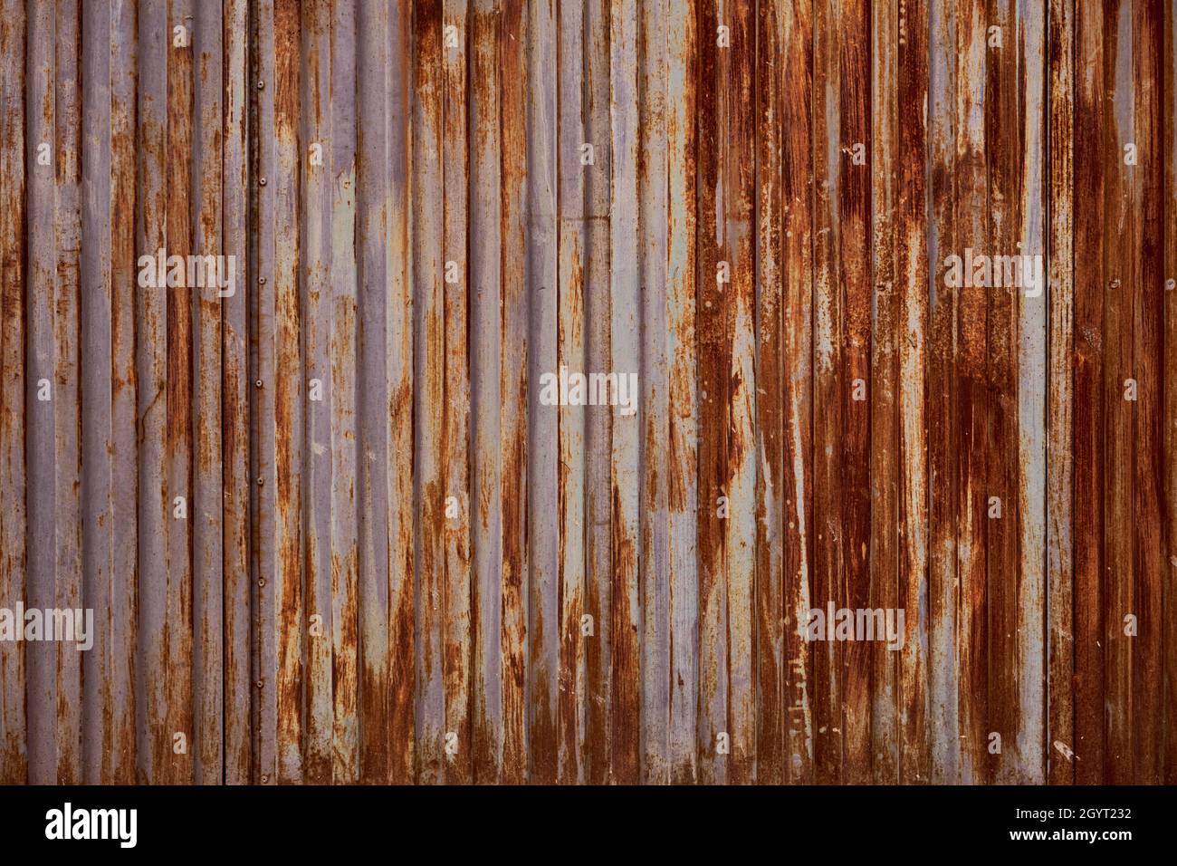 Old rusty metallic shutter with worn out peeling paint, grunge ...