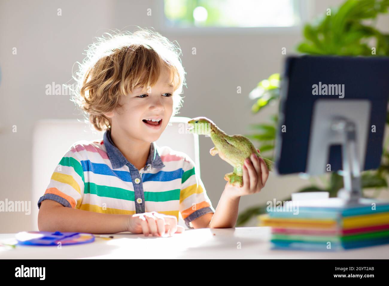 Online remote learning. School kids with computer having video ...