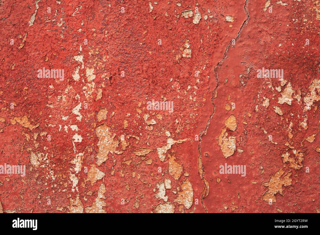 Old wall detail with worn out red peeling paint, grunge background or ...