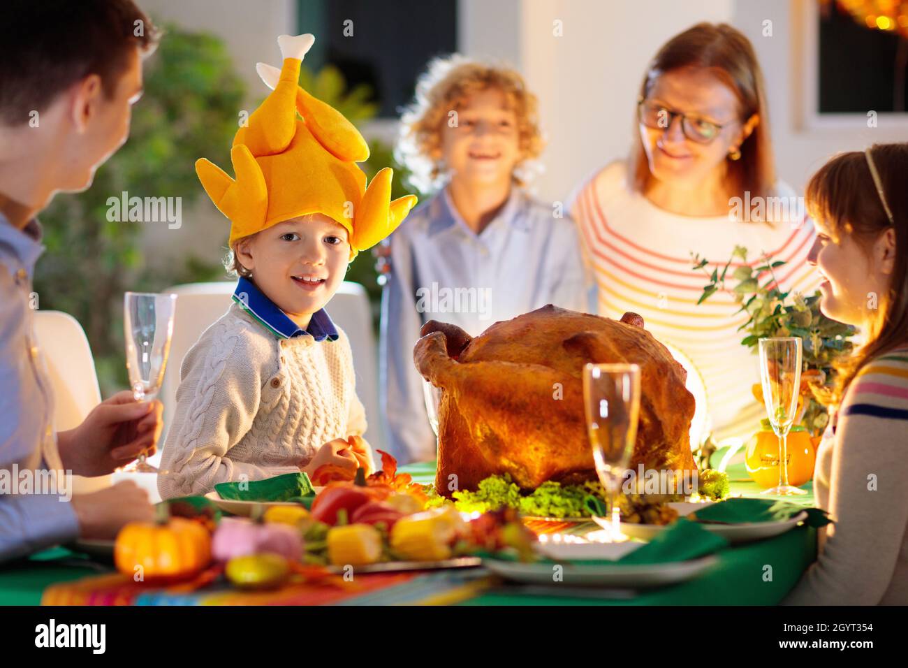 Family at Thanksgiving dinner. Parents, grandparents and kids enjoy ...