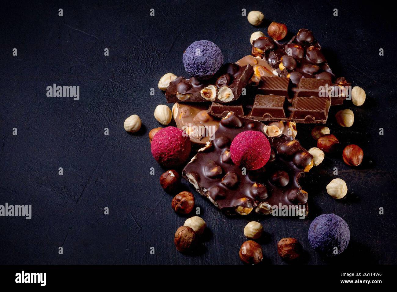 Chocolate bar, crushed pieces of dark chocolate and nuts. Praline ...