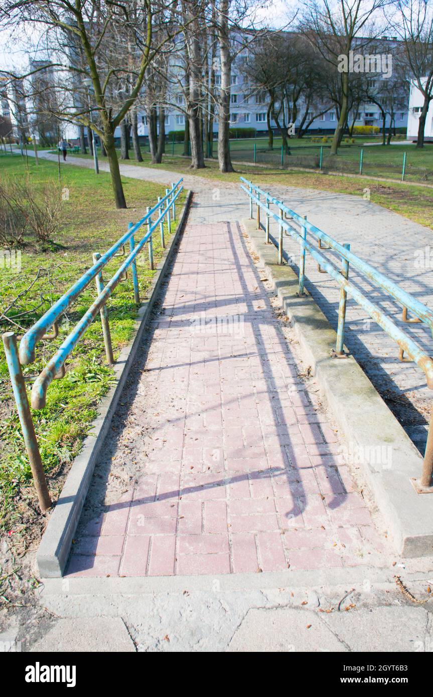 Path with a barrier leading to a park Stock Photo - Alamy