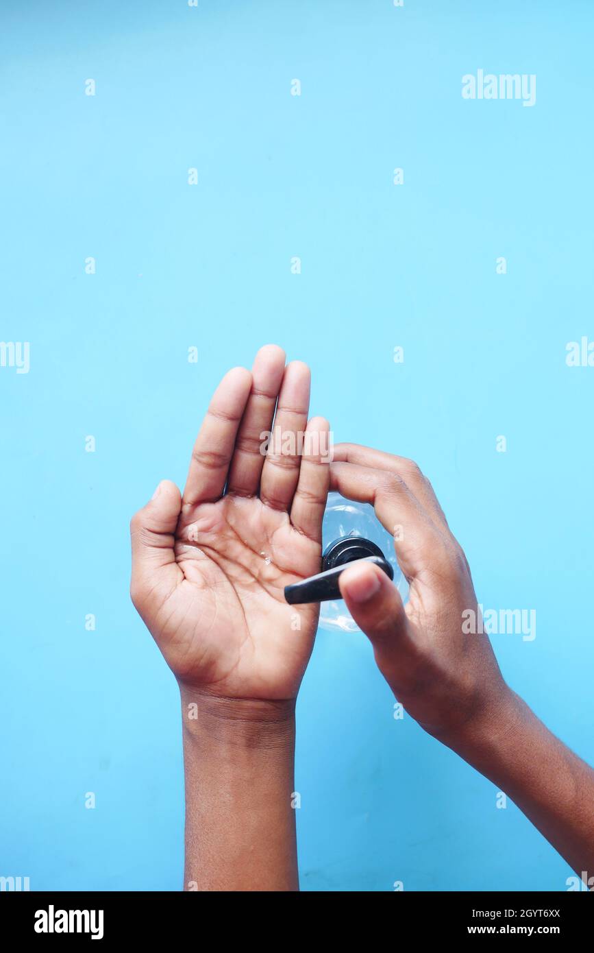 Using sanitizer liquid for preventing corona virus Stock Photo - Alamy