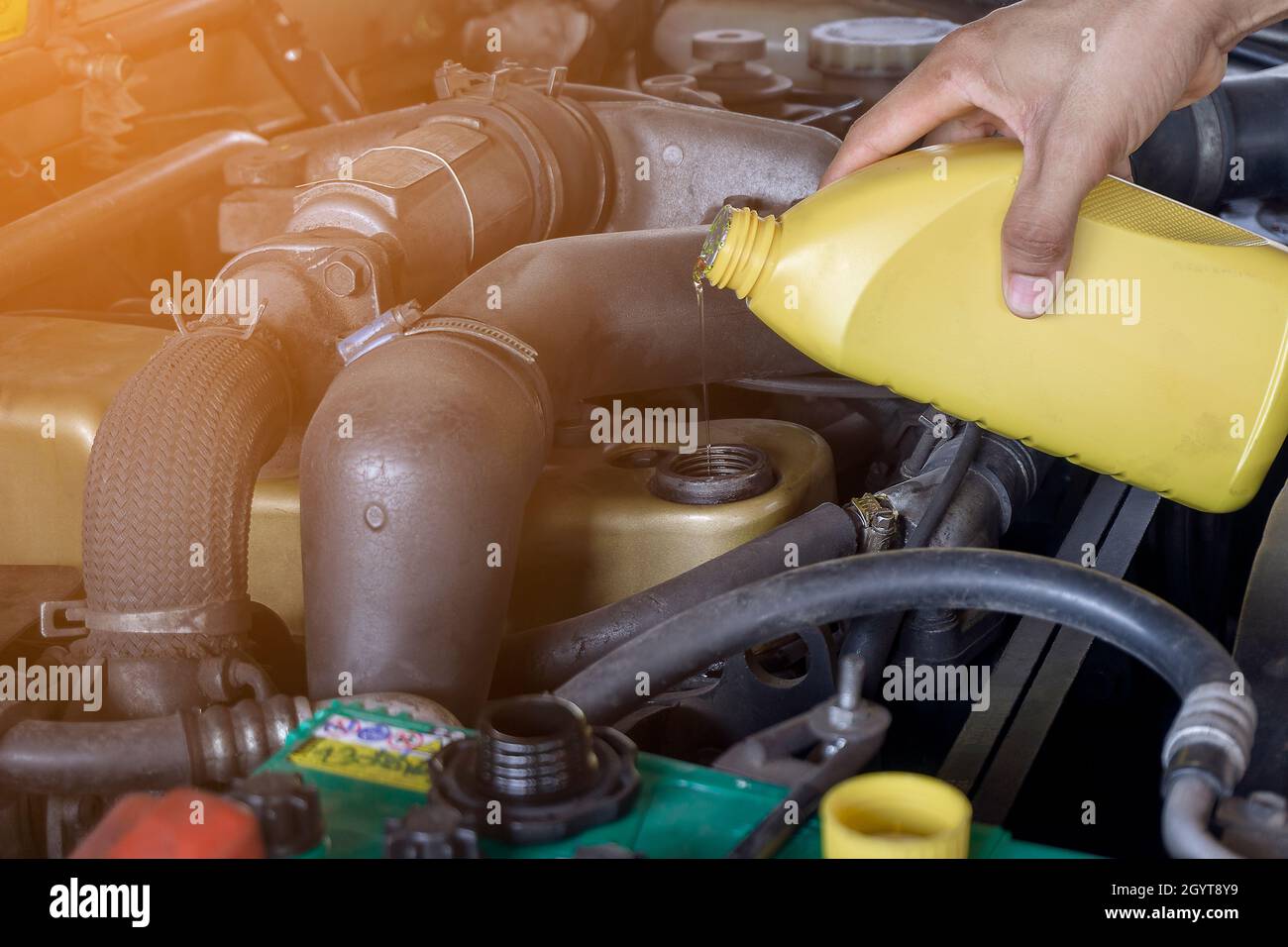 Close up hands of mechanic doing car service and maintenance. Oil and ...