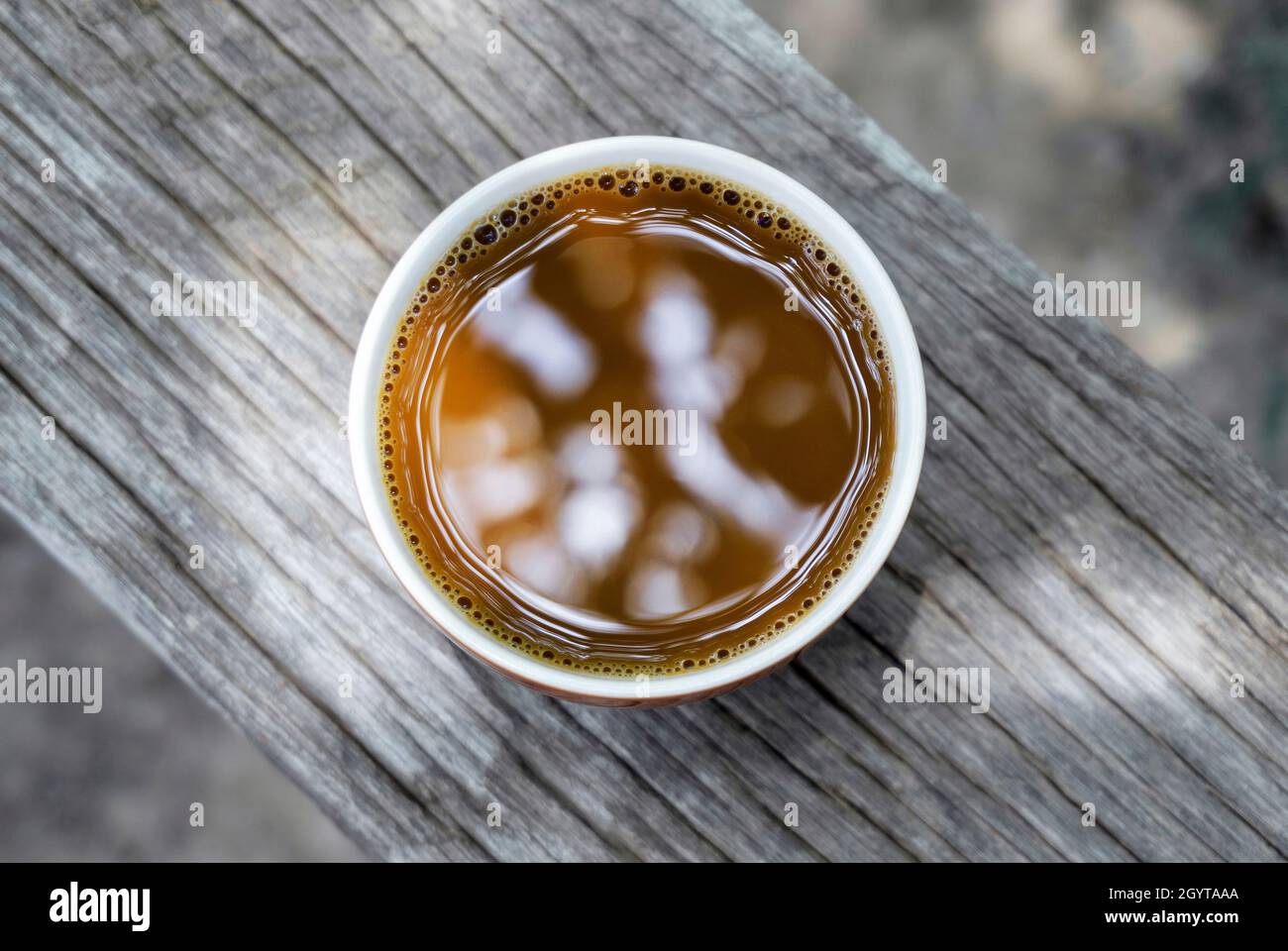 Top view of a brown hot coffee cup on an old wood table vintage style ...